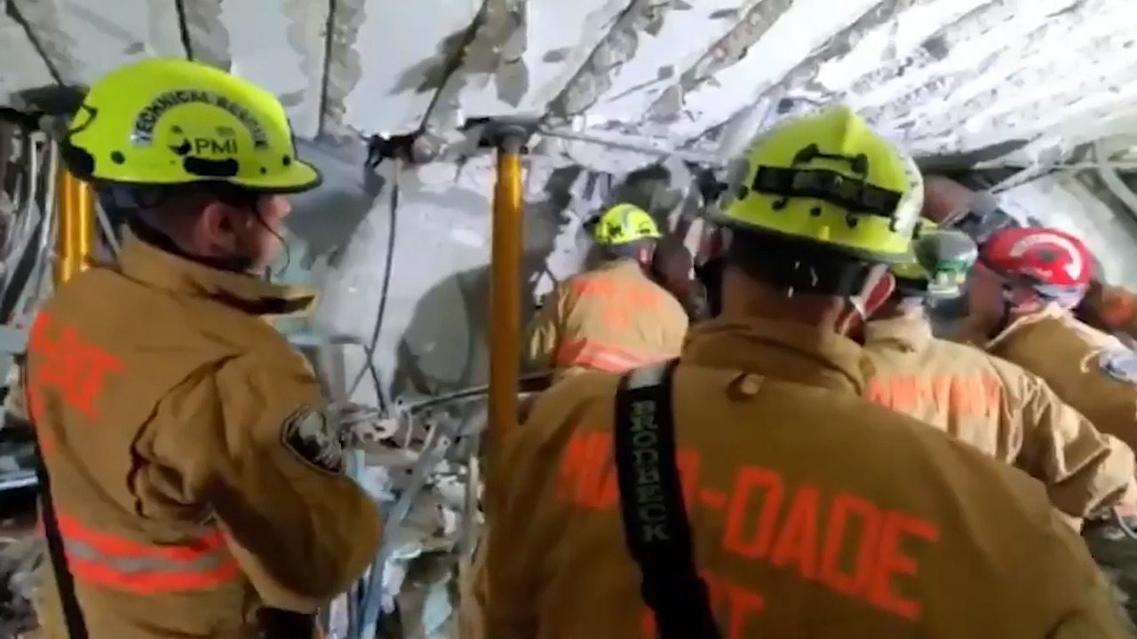 First responders work in basement parking garage of collapsed Surfside ...