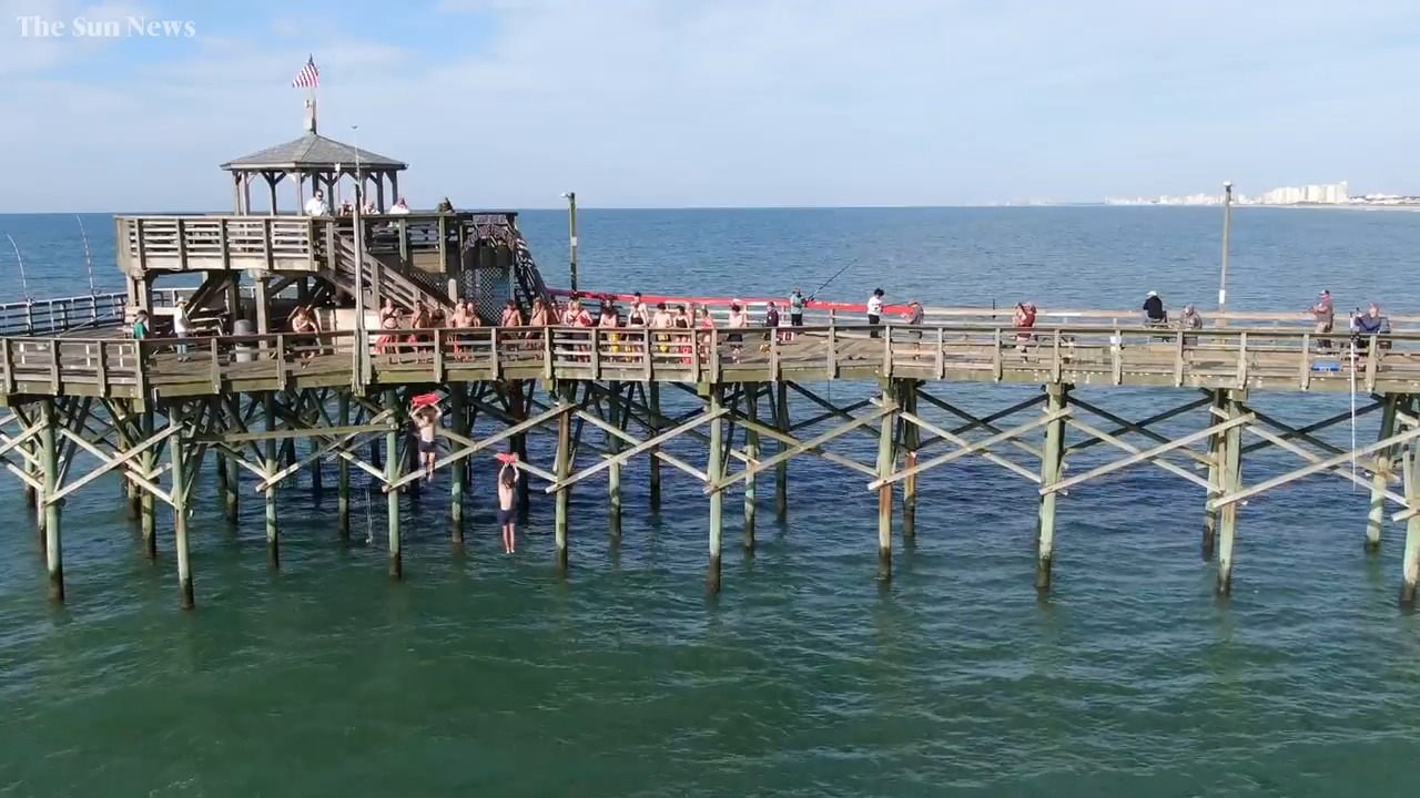 Watch North Myrtle Beach Lifeguards jump off the end of Cherry Grove ...