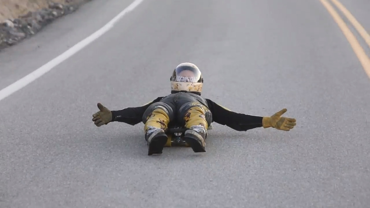 CJ Wilkinson rides a downhill street luge in the company of longboard ...