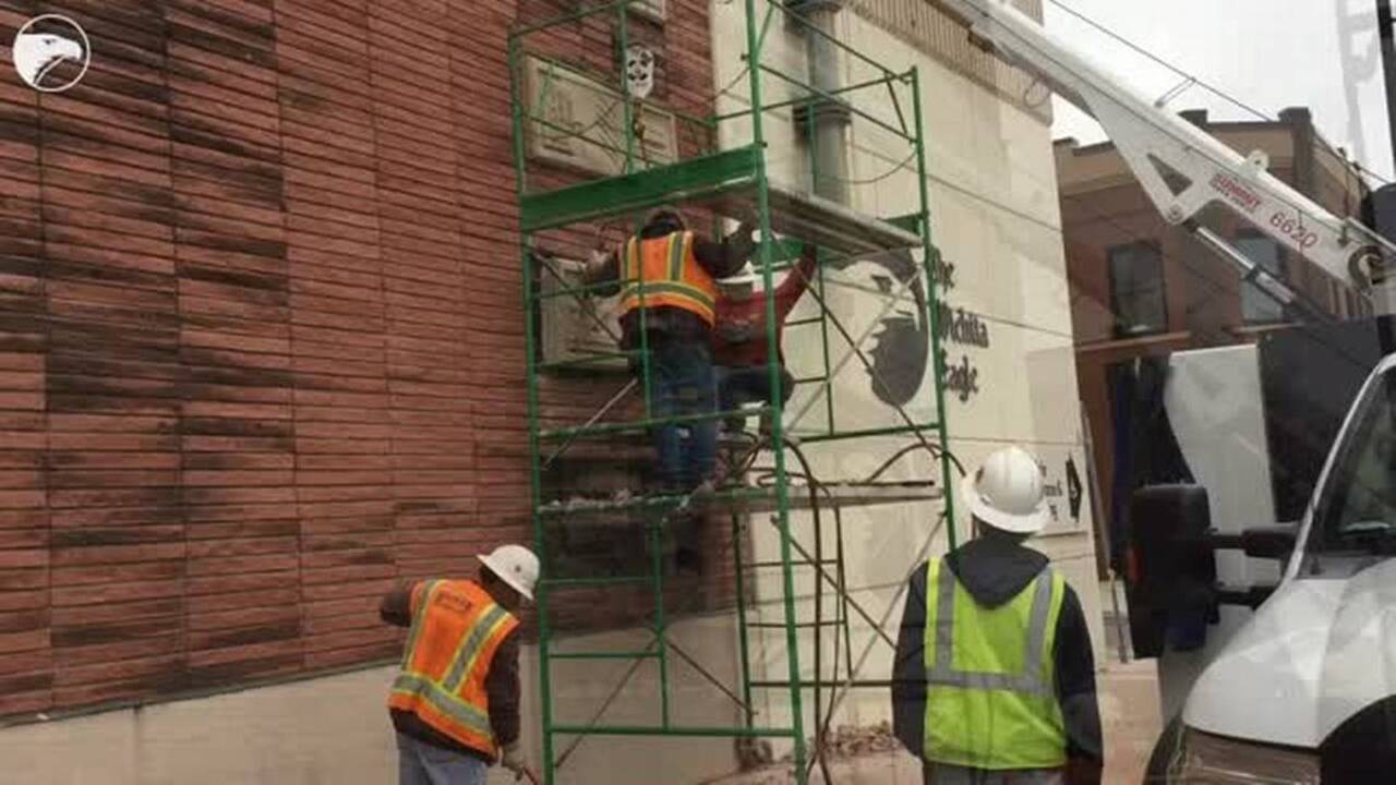 Workers remove artwork from facade of Eagle building | Wichita Eagle