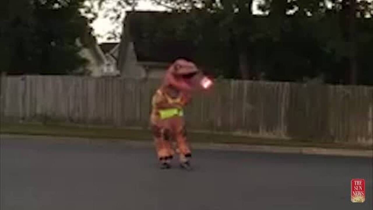 Detective goes undercover as T-rex to direct traffic at elementary ...