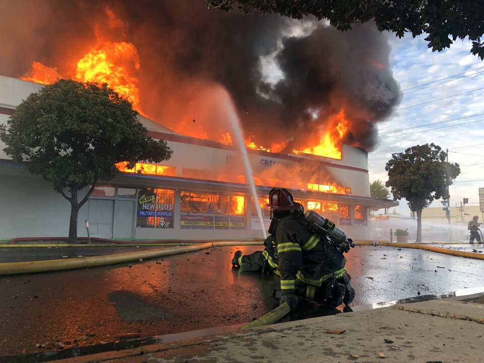 A four-alarm fire spread between two commercial buildings in downtown ...