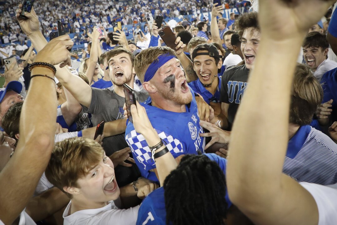 UK football fans storm Kroger Field after Florida win | Lexington ...